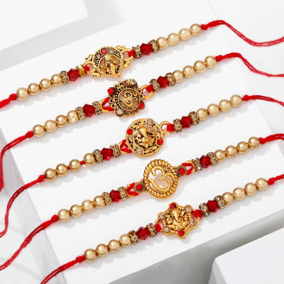Buy/Send Om & Ganesha Metal Rakhi with CZ Stones Online | IGP | JVS1287624
